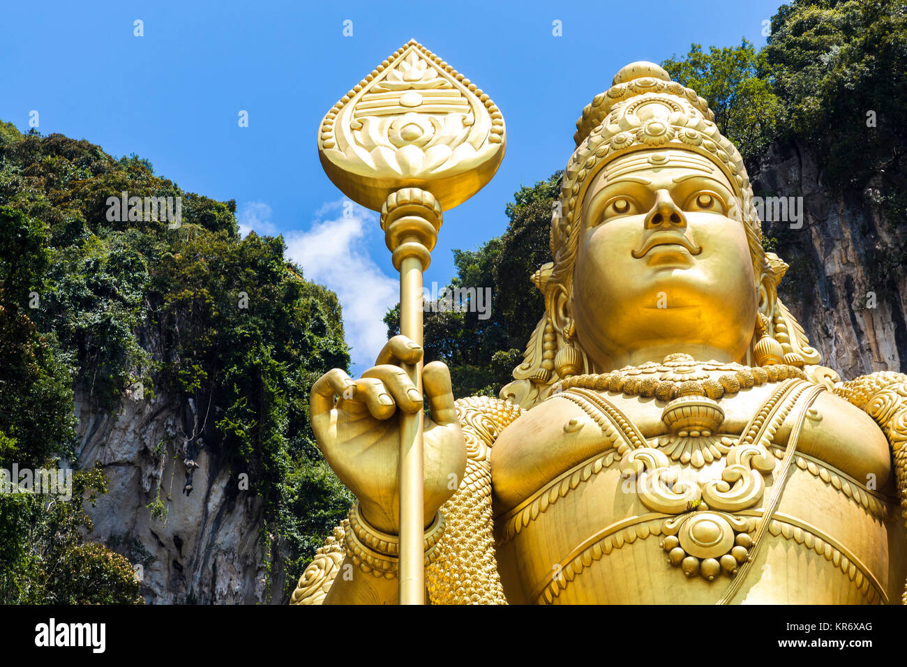 Low angle close up of colossal golden statue of Hindu deity Stock Photo ...