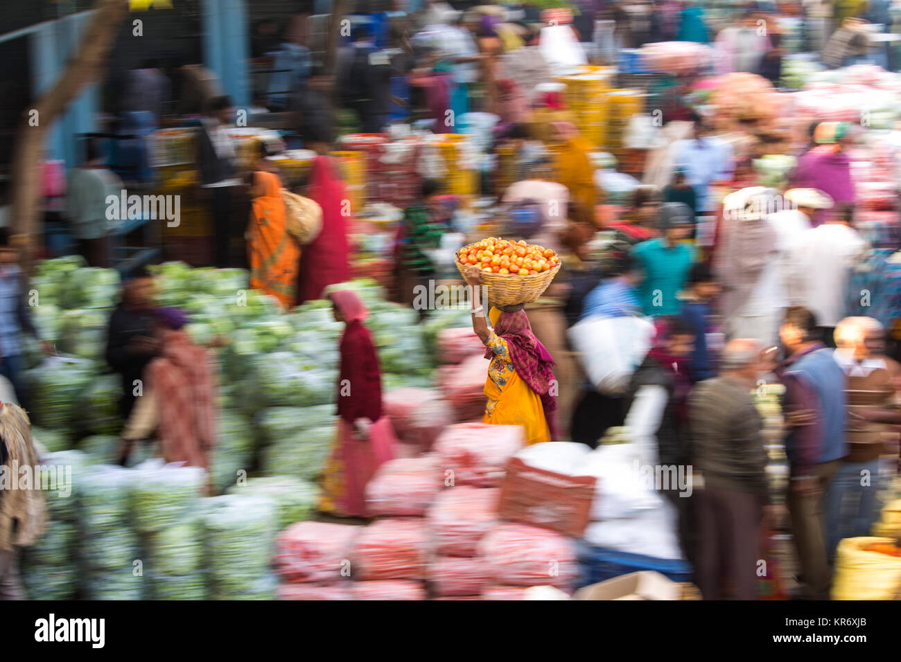 High angle view of fruit and vegetable market, woman carrying a load on ...