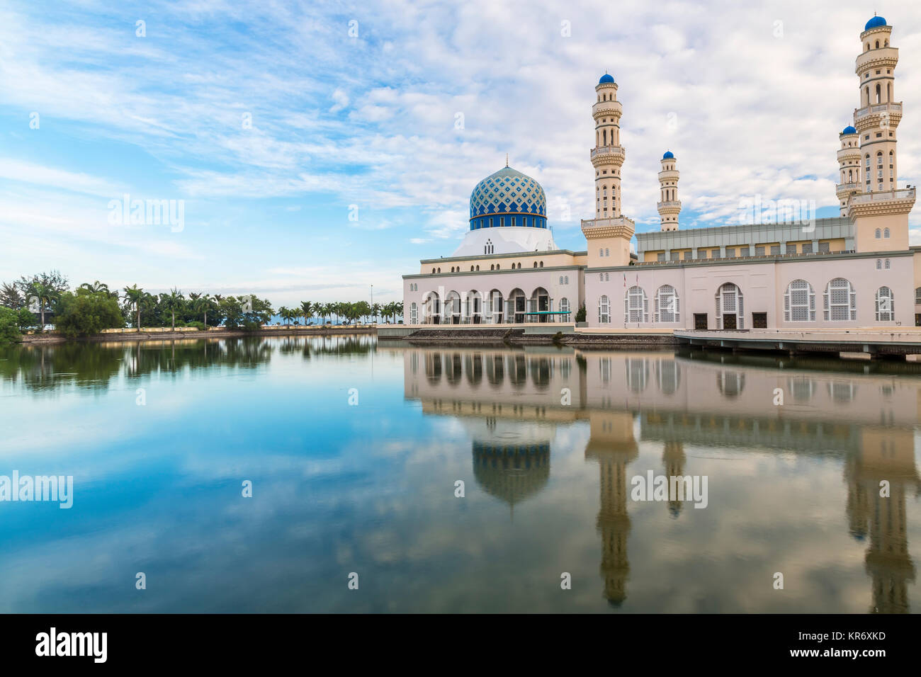 Exterior view of mosque with white washed facade and blue dome ...