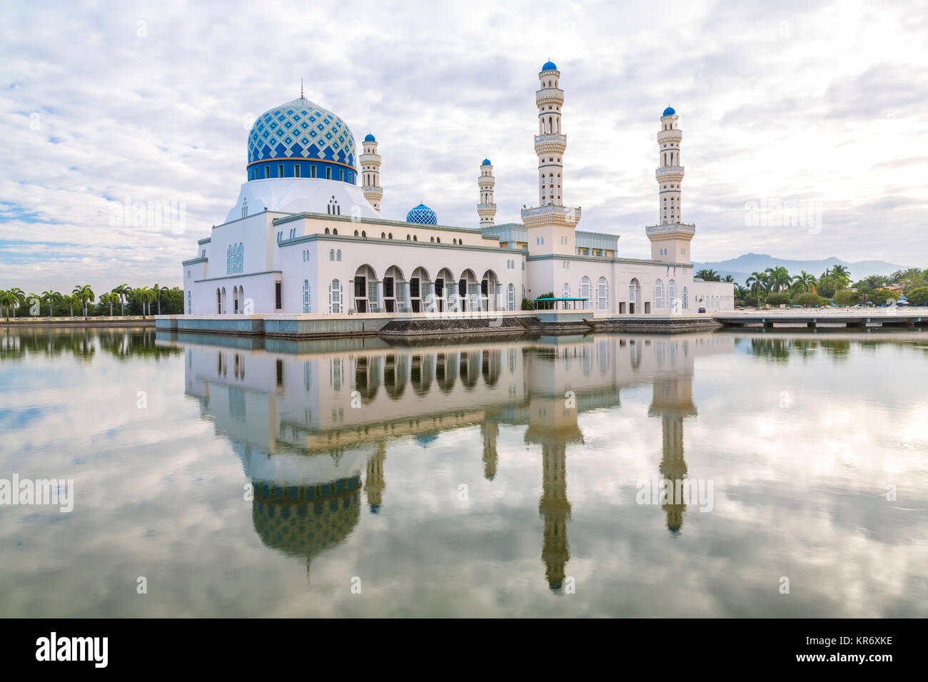 Exterior view of mosque with white washed facade and blue dome ...