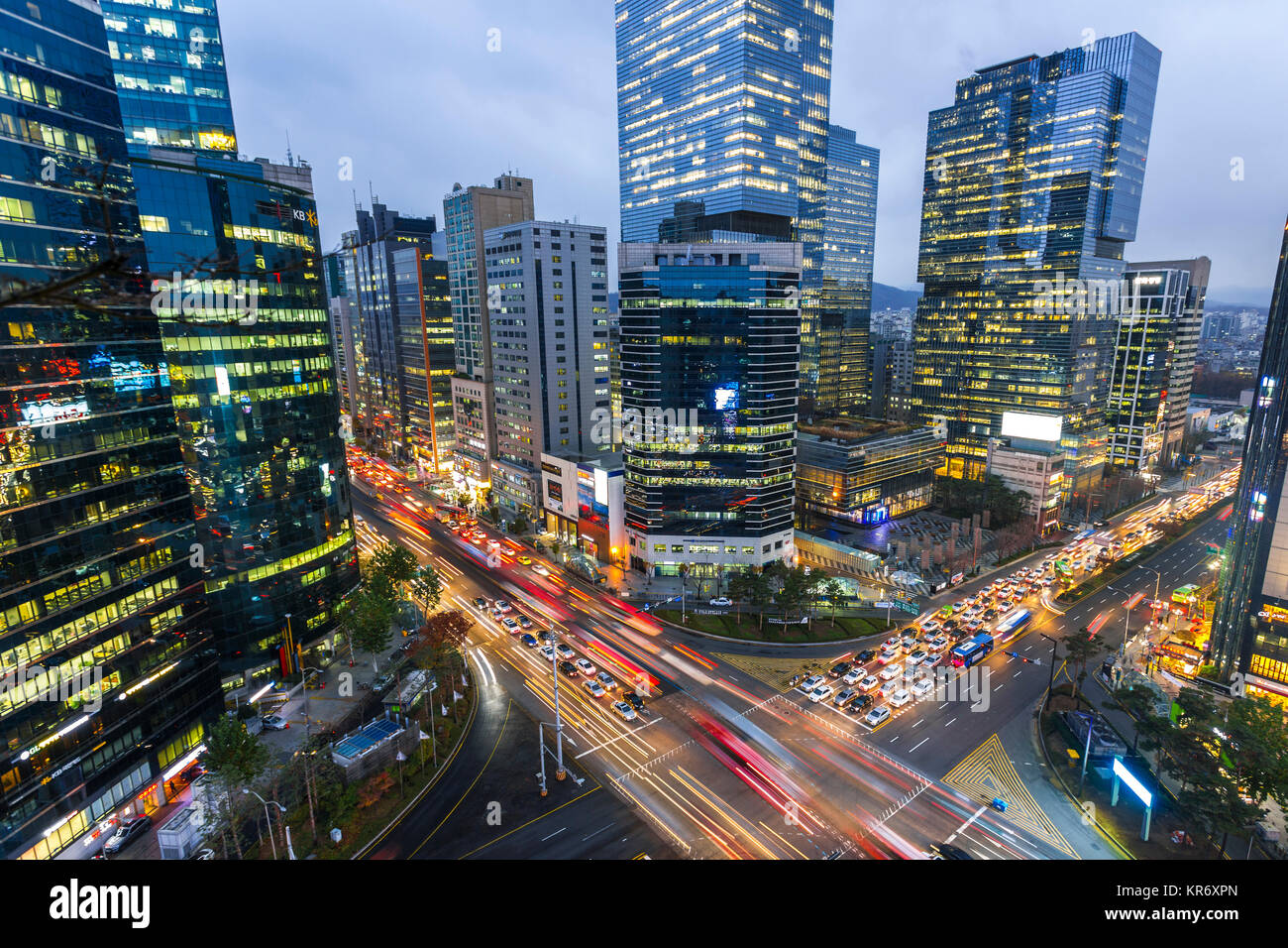 High angle view over city with illuminated skyscrapers, busy street ...