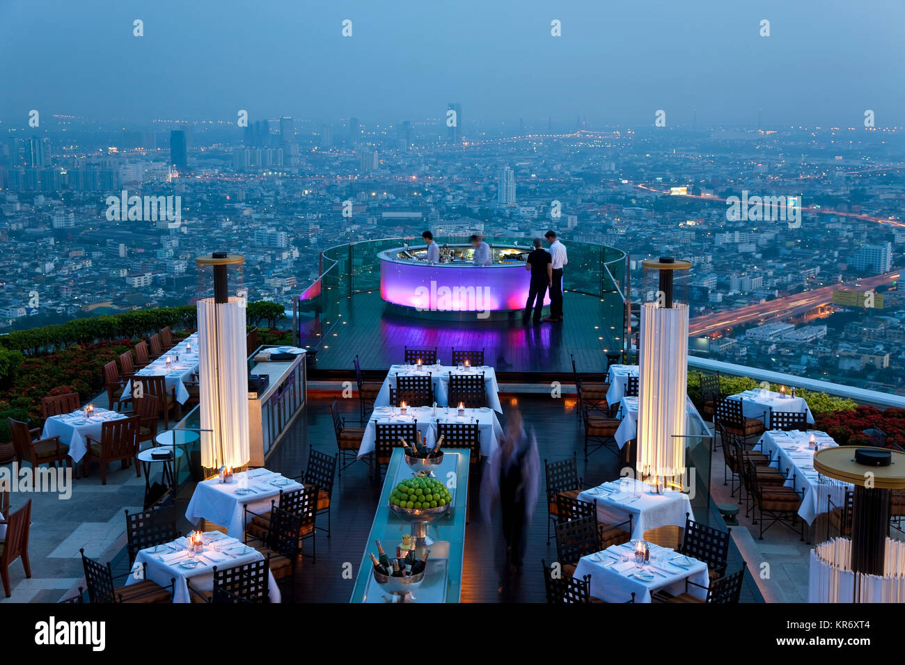 High angle view of rooftop restaurant on a skyscraper, illuminated ...