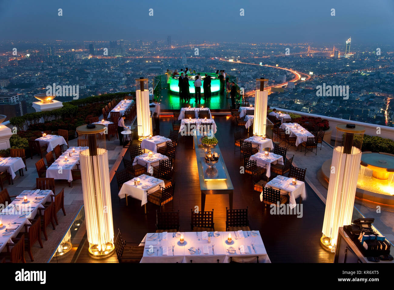 High angle view of rooftop restaurant on a skyscraper, illuminated ...