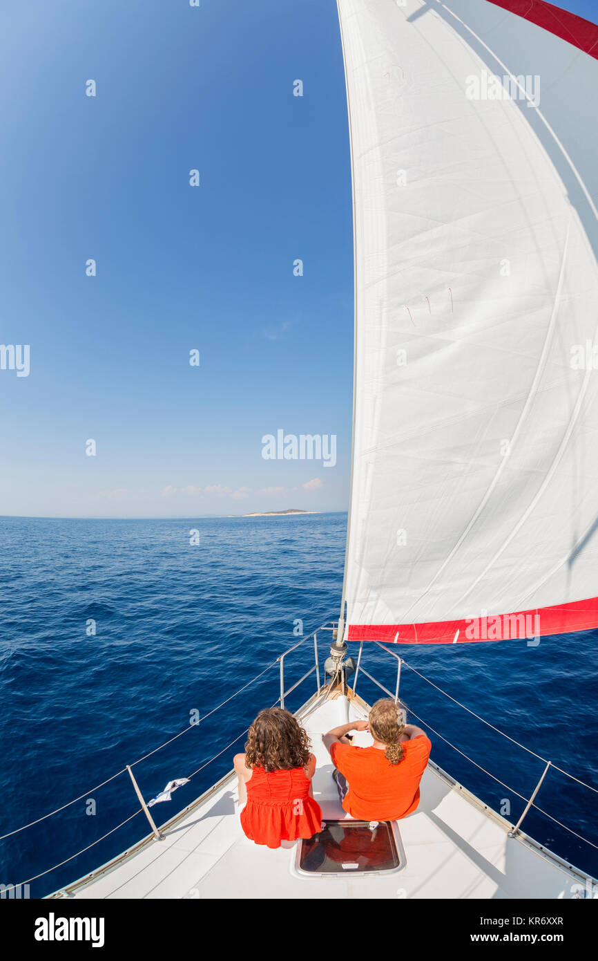 High angle rear view of man and woman sitting side by side near the bow ...