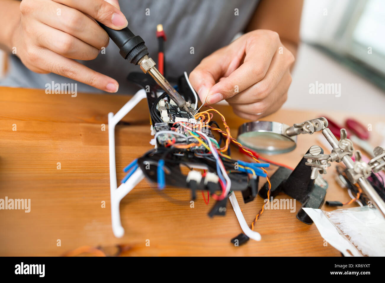 Welding the cable on flying drone Stock Photo - Alamy