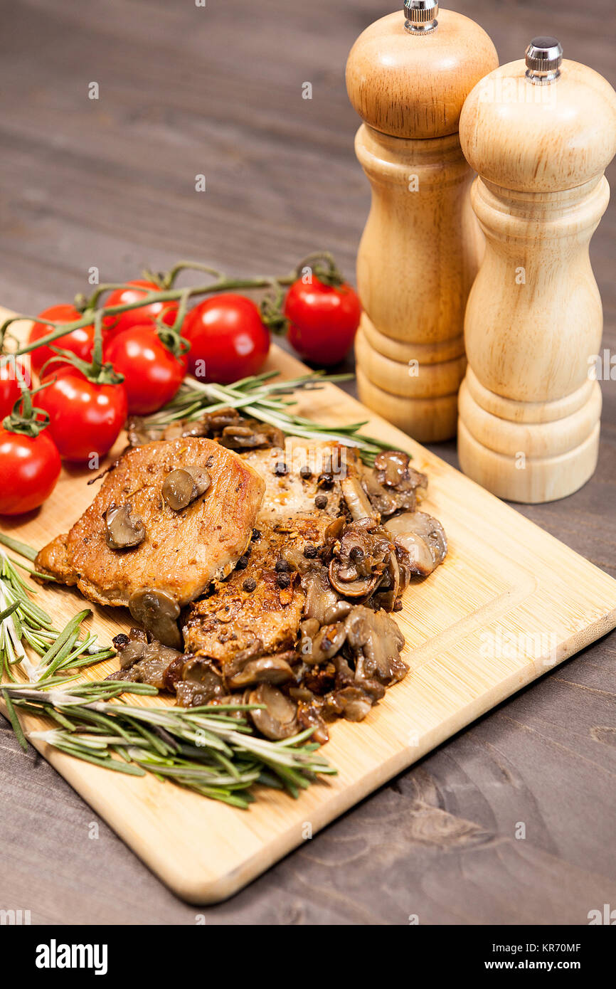 Close up top view on pork steak with grilled mushrooms Stock Photo - Alamy