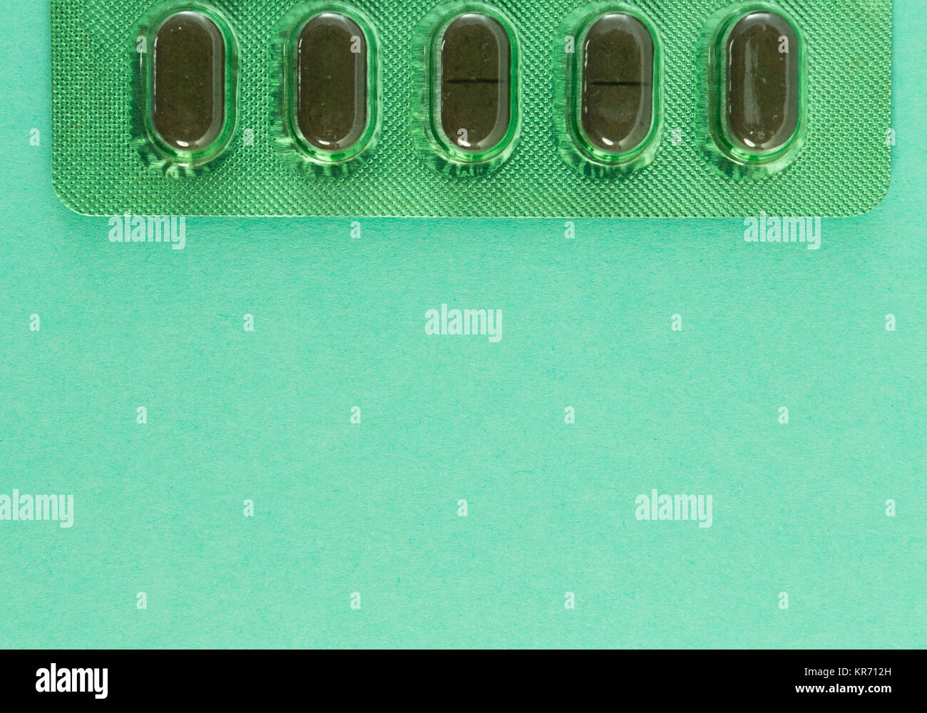 Closeup of natural herbal green tablets blister on copyspace and ...