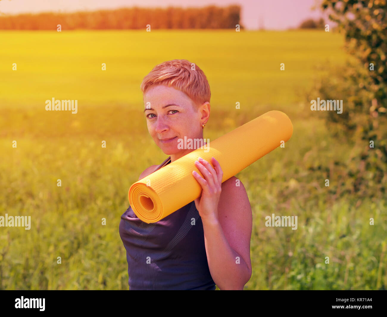 Woman Holding Rolled Up Exercise Mat Stock Photo - Alamy