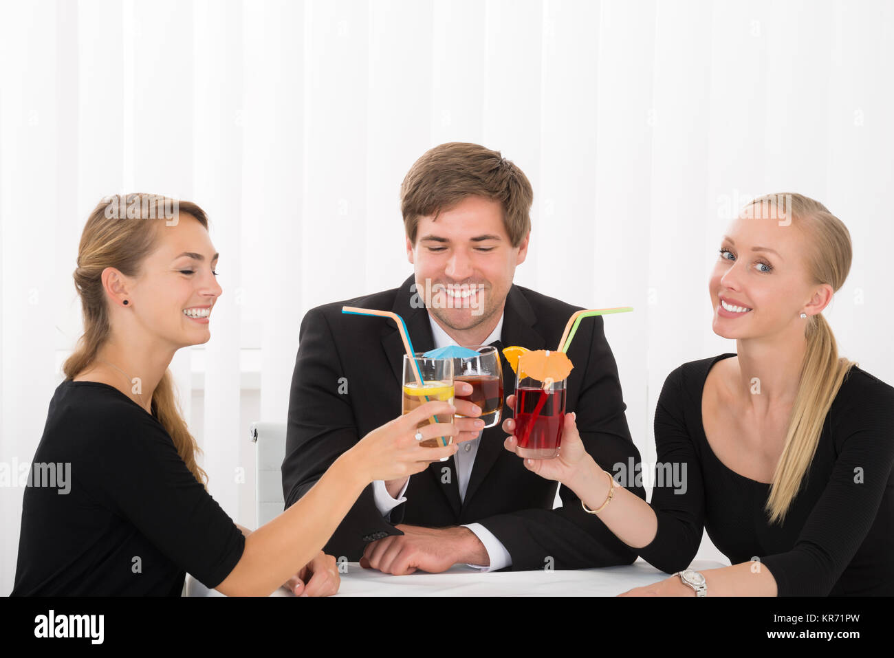 Group Of Friends Drinking Cocktails Stock Photo - Alamy