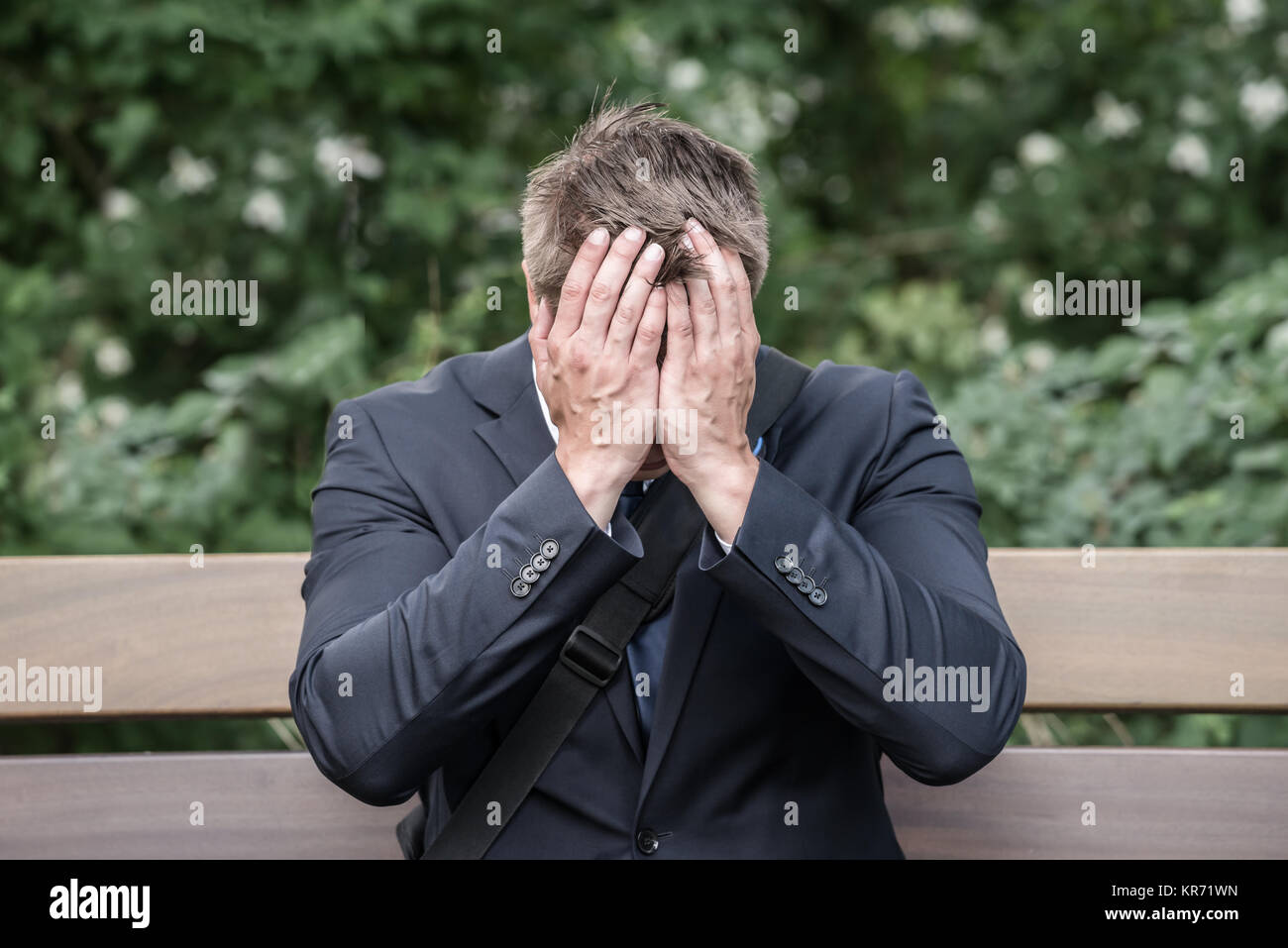 Sad Businessman Sitting On Bench Stock Photo - Alamy