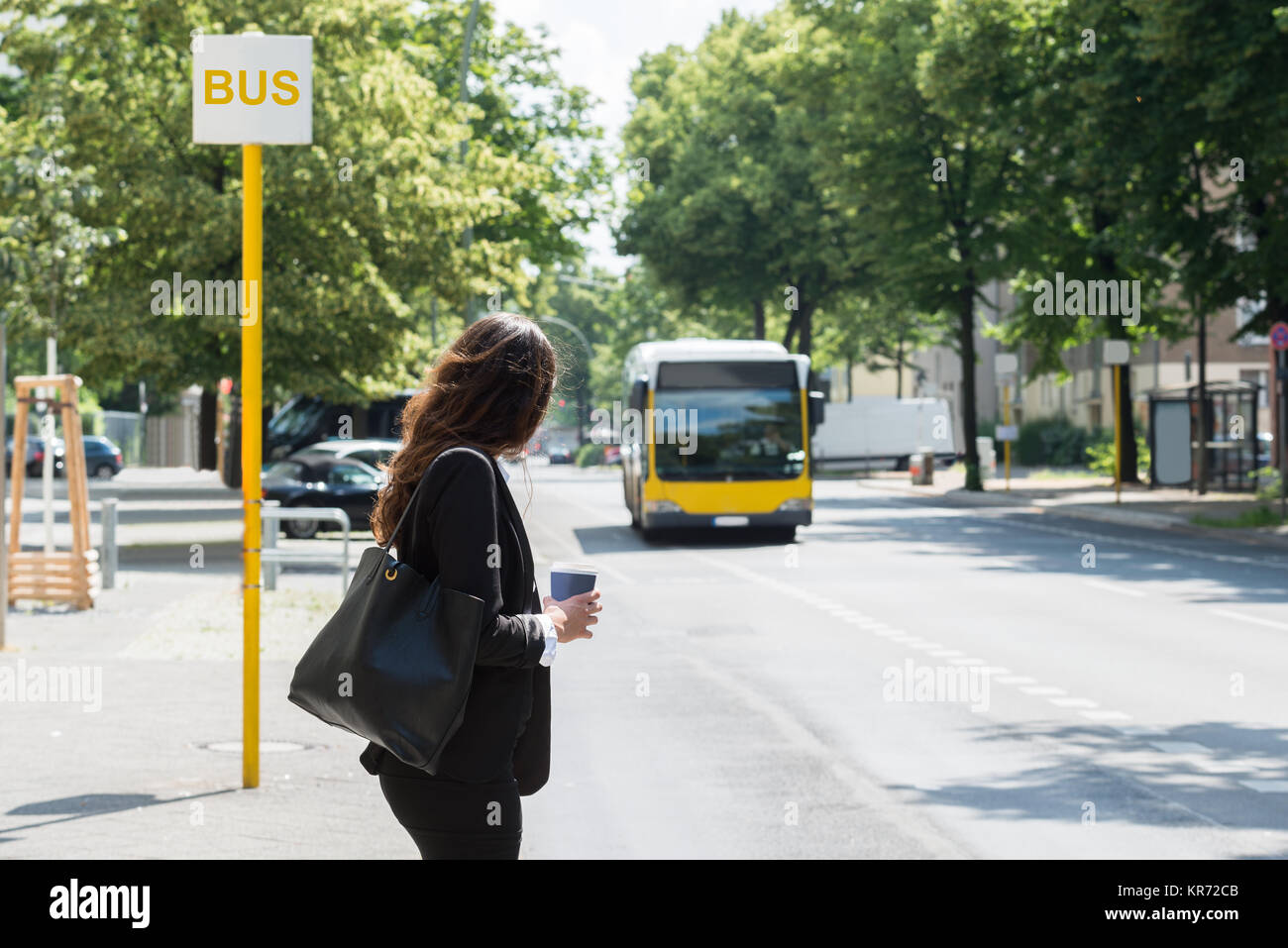 Businesswoman Waiting For Bus Stock Photo - Alamy