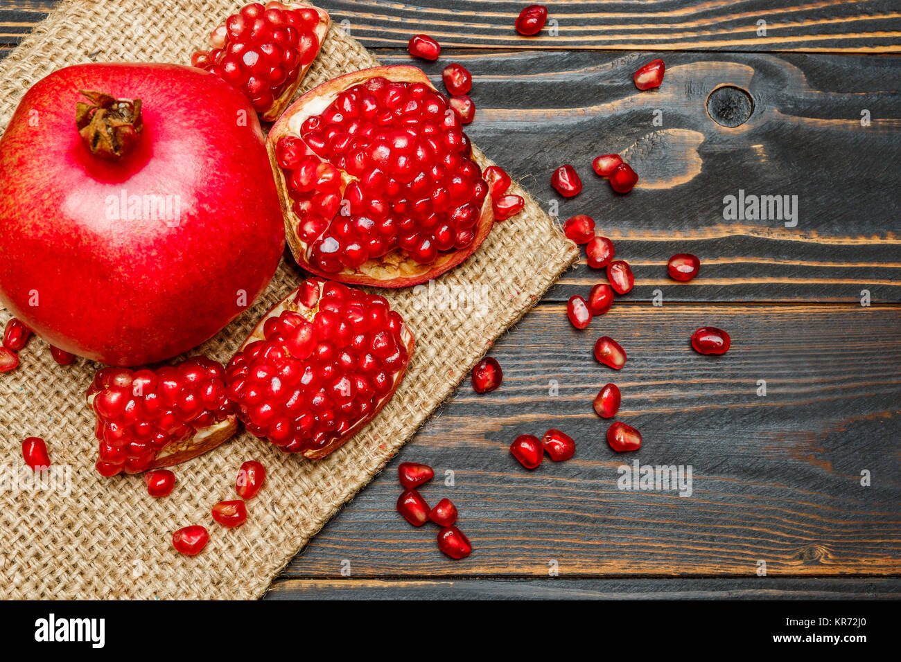 Pomegranate and seeds close-up on wooden background Stock Photo - Alamy