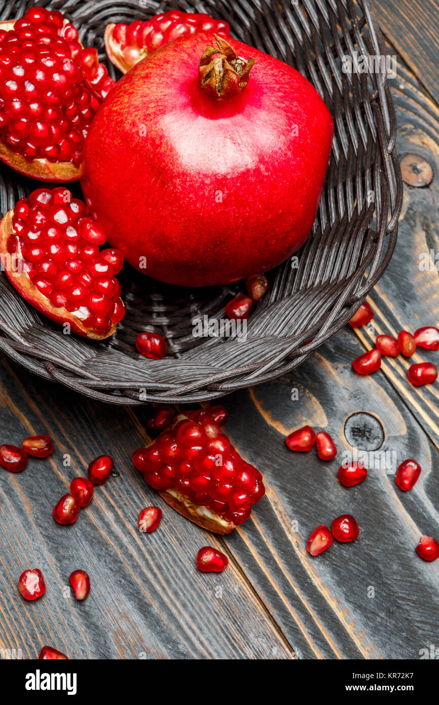 Pomegranate and seeds close-up on wooden background Stock Photo - Alamy