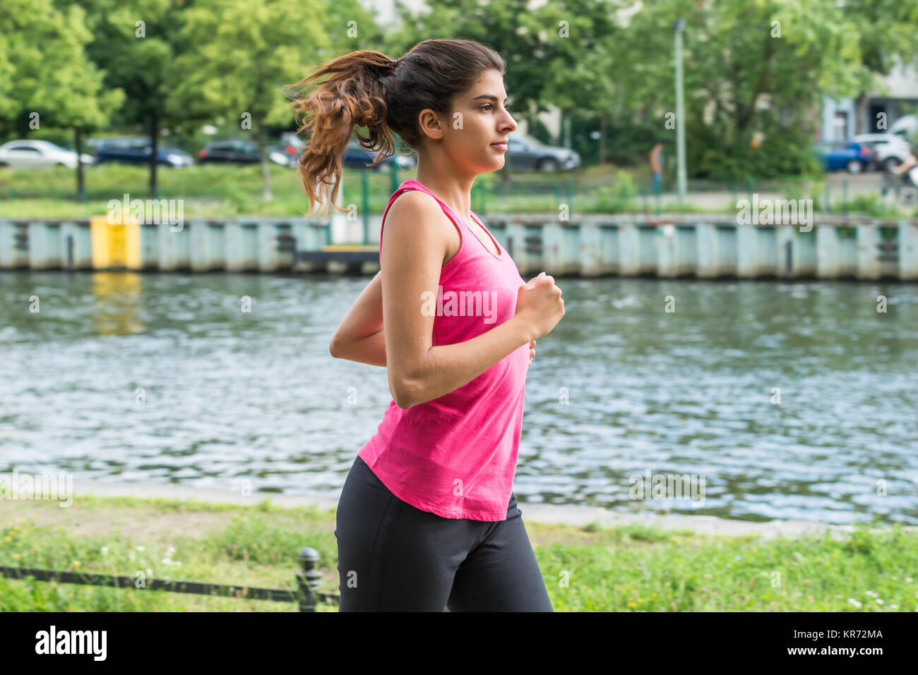 Female Athlete Running Near The Pool Stock Photo - Alamy