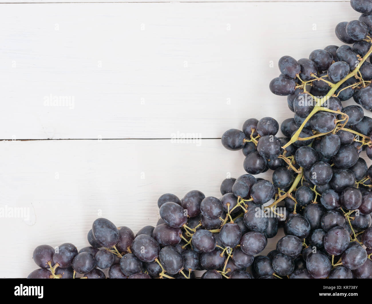 Purple grapes on wooden table Stock Photo - Alamy