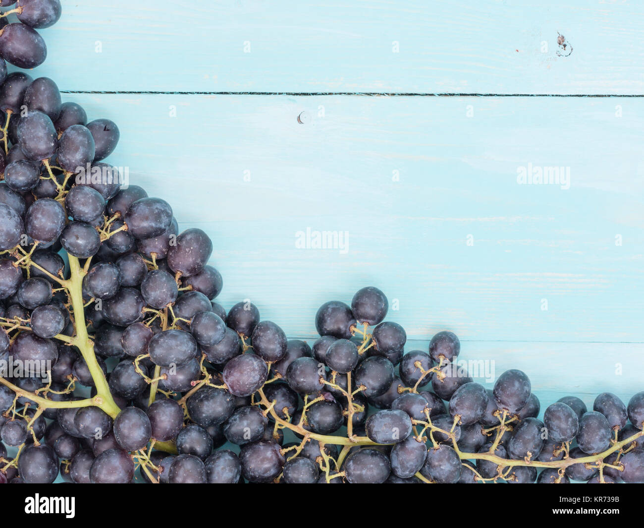 Purple grapes on wooden table Stock Photo - Alamy