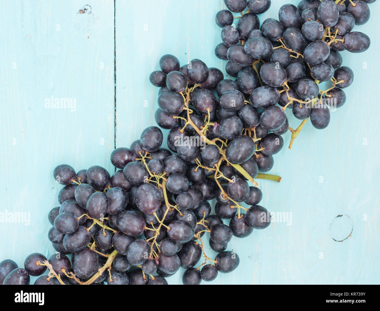 Purple grapes on wooden table Stock Photo - Alamy