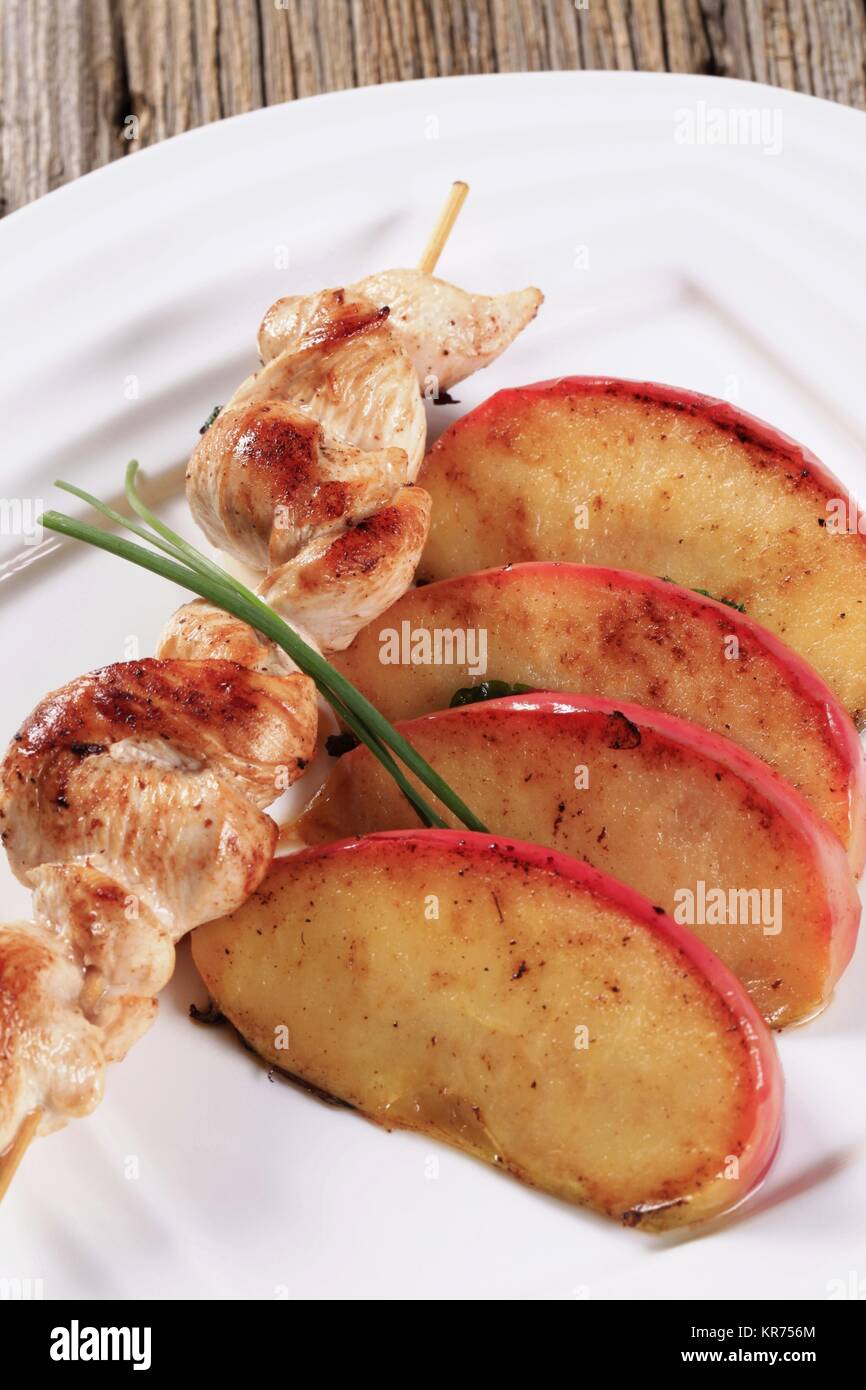 Chicken skewer and slices of apple Stock Photo - Alamy