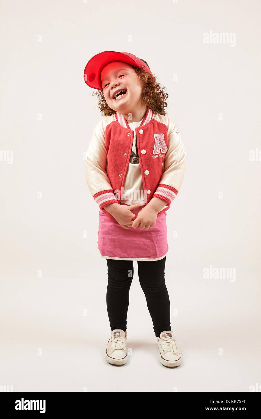 Little Girl Fashion Model With Red Cap Stock Photo - Alamy