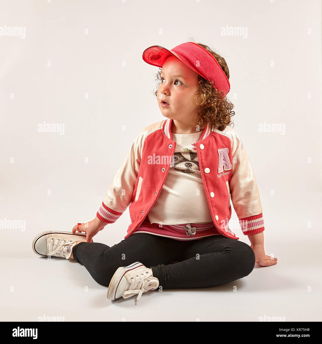 Little Girl Fashion Model With Red Cap Stock Photo - Alamy