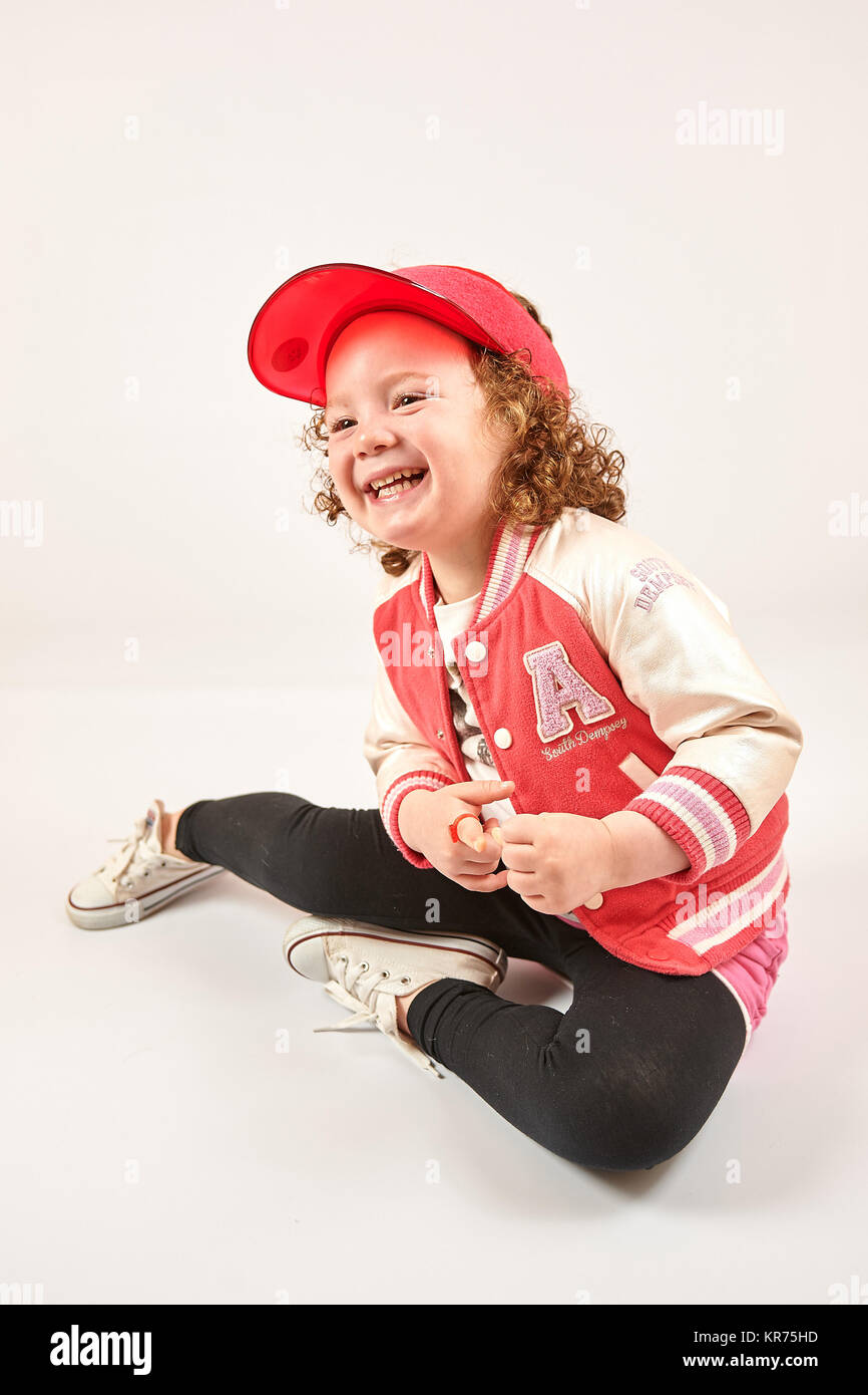 Little Girl Fashion Model With Red Cap Stock Photo - Alamy