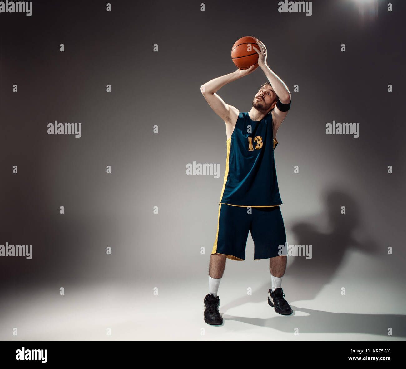 Full length portrait of a basketball player with ball Stock Photo - Alamy