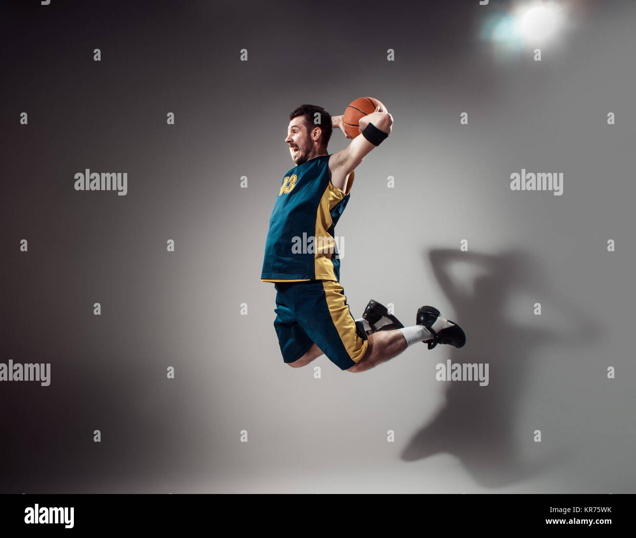 Full length portrait of a basketball player with ball Stock Photo - Alamy