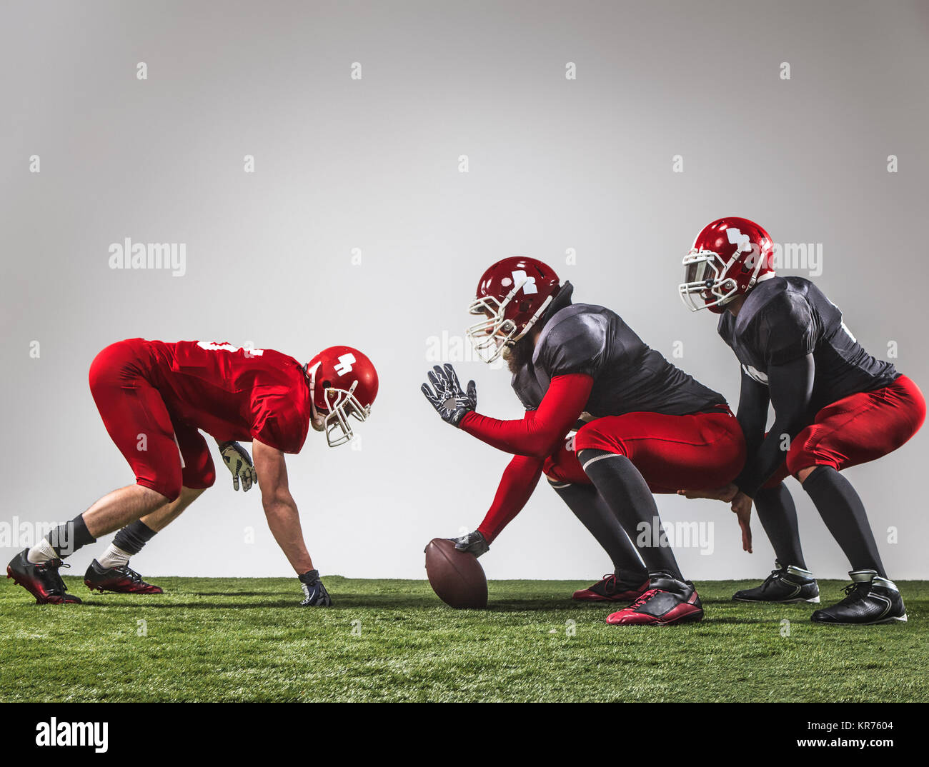 The three american football players in action Stock Photo - Alamy