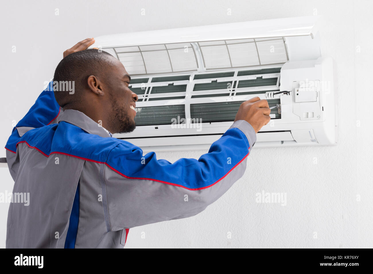 Technician Repairing Air Conditioner Stock Photo - Alamy