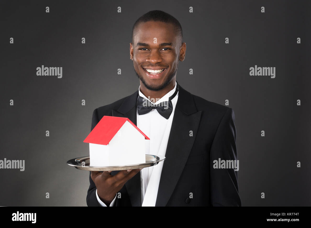 Waiter Holding House Model In Tray Stock Photo - Alamy