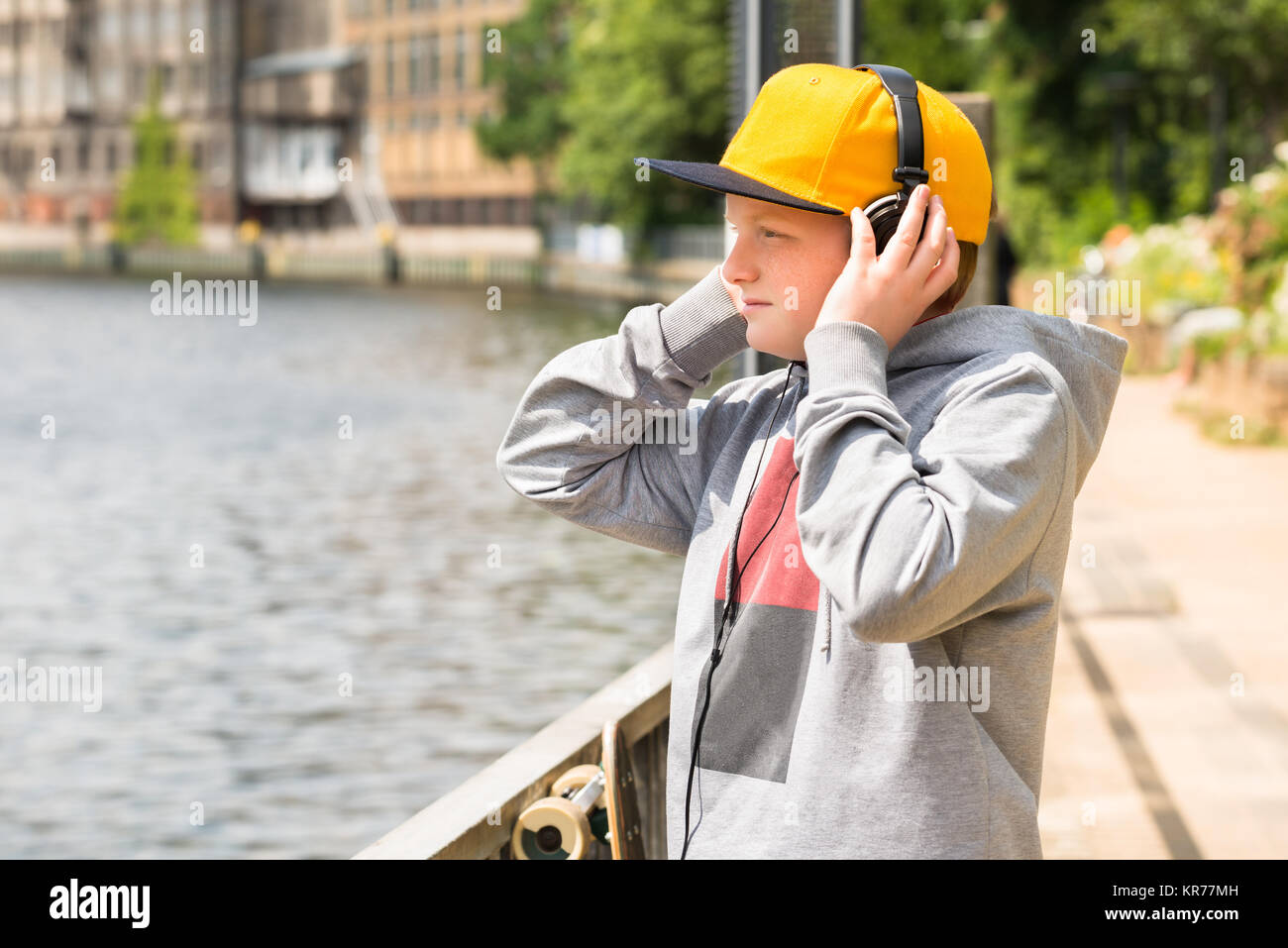 Boy Looking At Lake While Listening To Music Stock Photo - Alamy