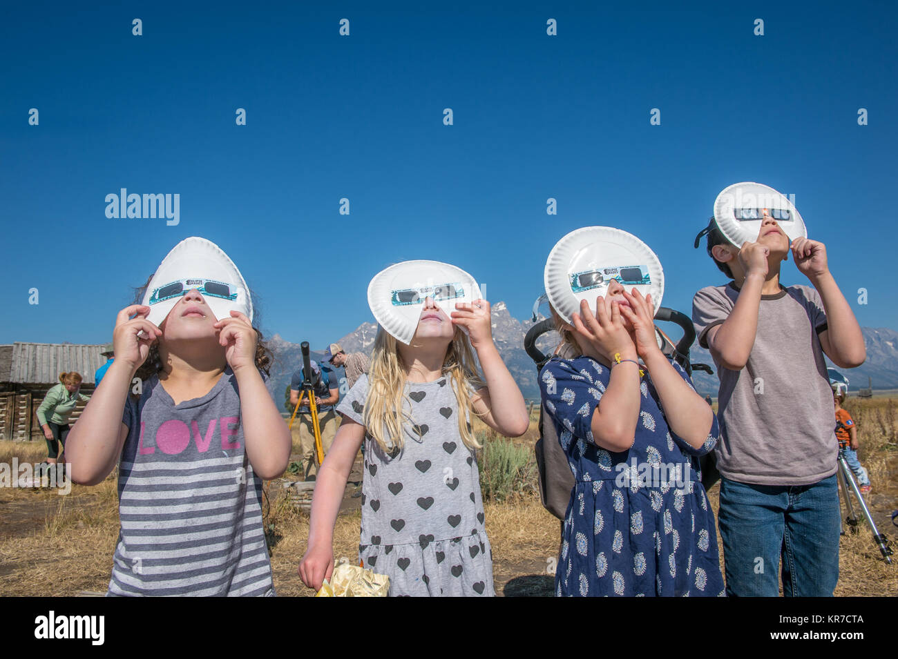 Group of children look up wearing eclipse glasses to watch Solar ...