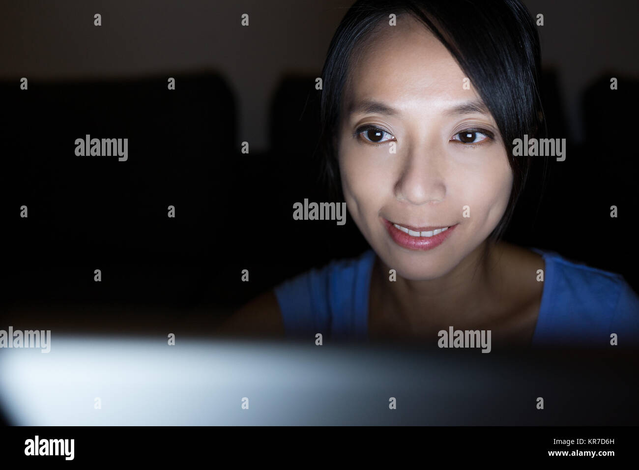 Woman working on laptop computer at night Stock Photo - Alamy