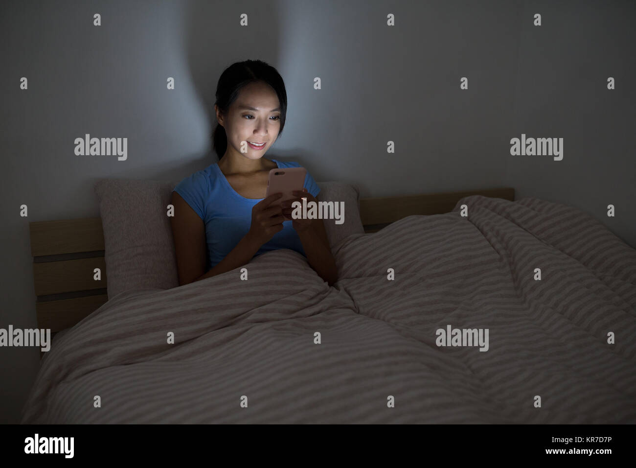 Woman using mobile phone at night Stock Photo - Alamy