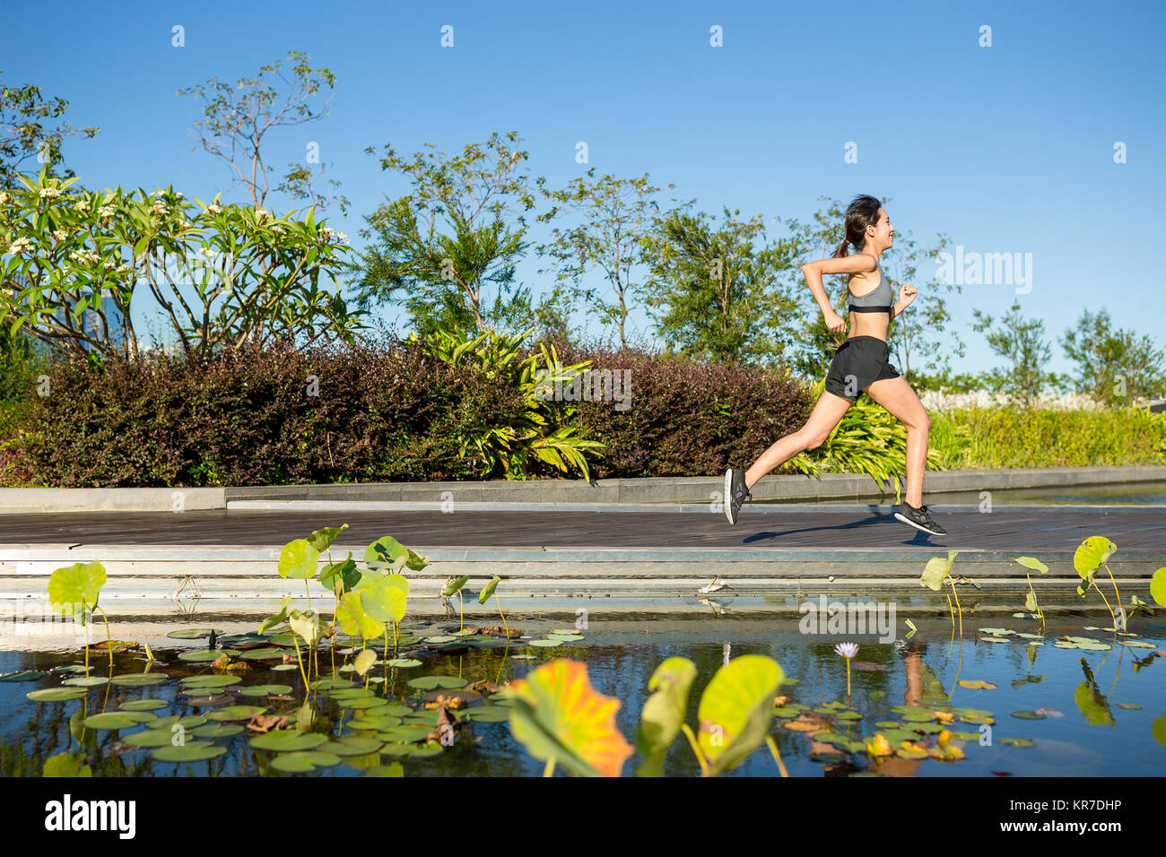 Woman run in park at outdoor Stock Photo - Alamy