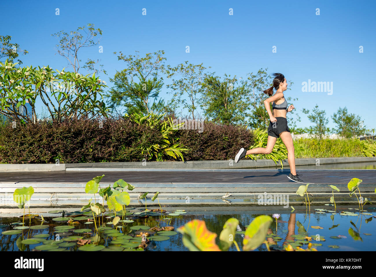 Jogging woman running in park Stock Photo - Alamy