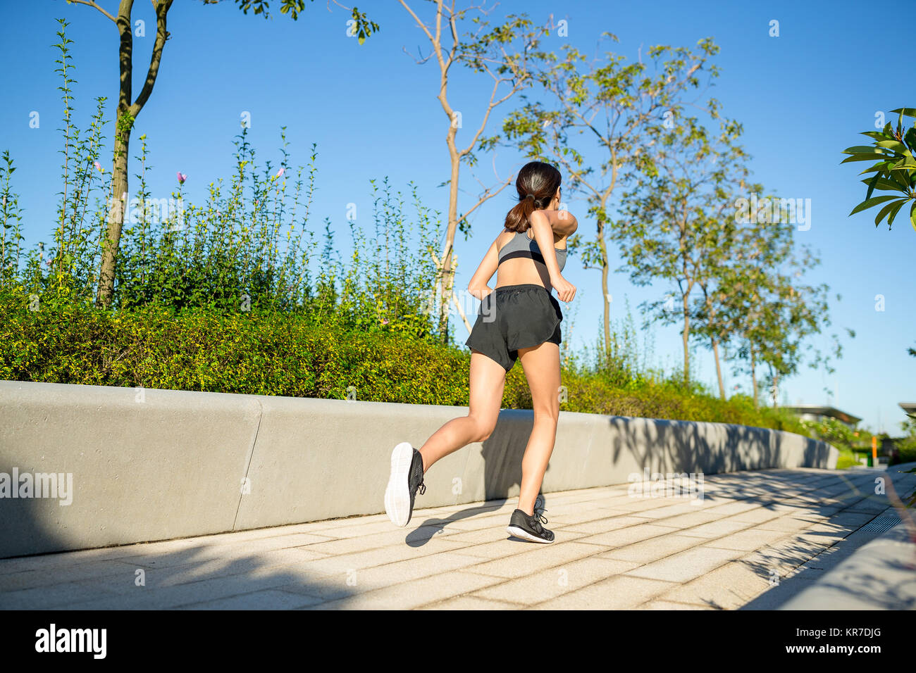 Back view of woman running at outdoor Stock Photo - Alamy