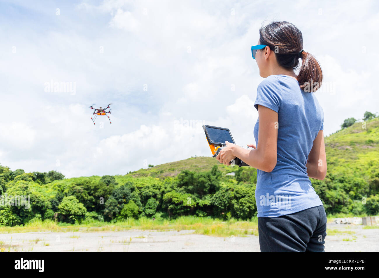 Young Woman remote flying drone Stock Photo - Alamy