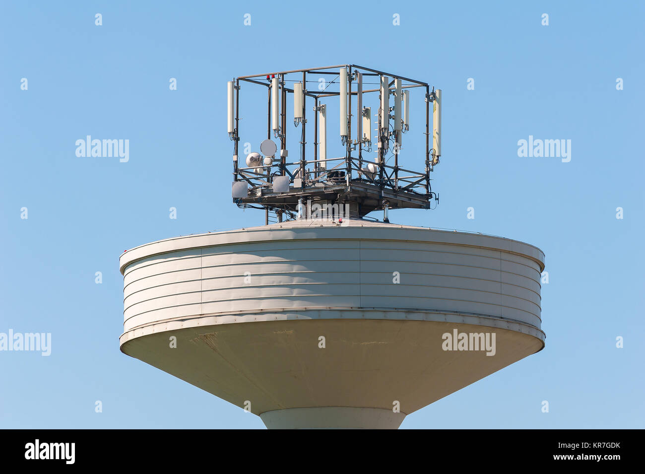 Water tank tower surmounted with a telephone repeater antennas against ...