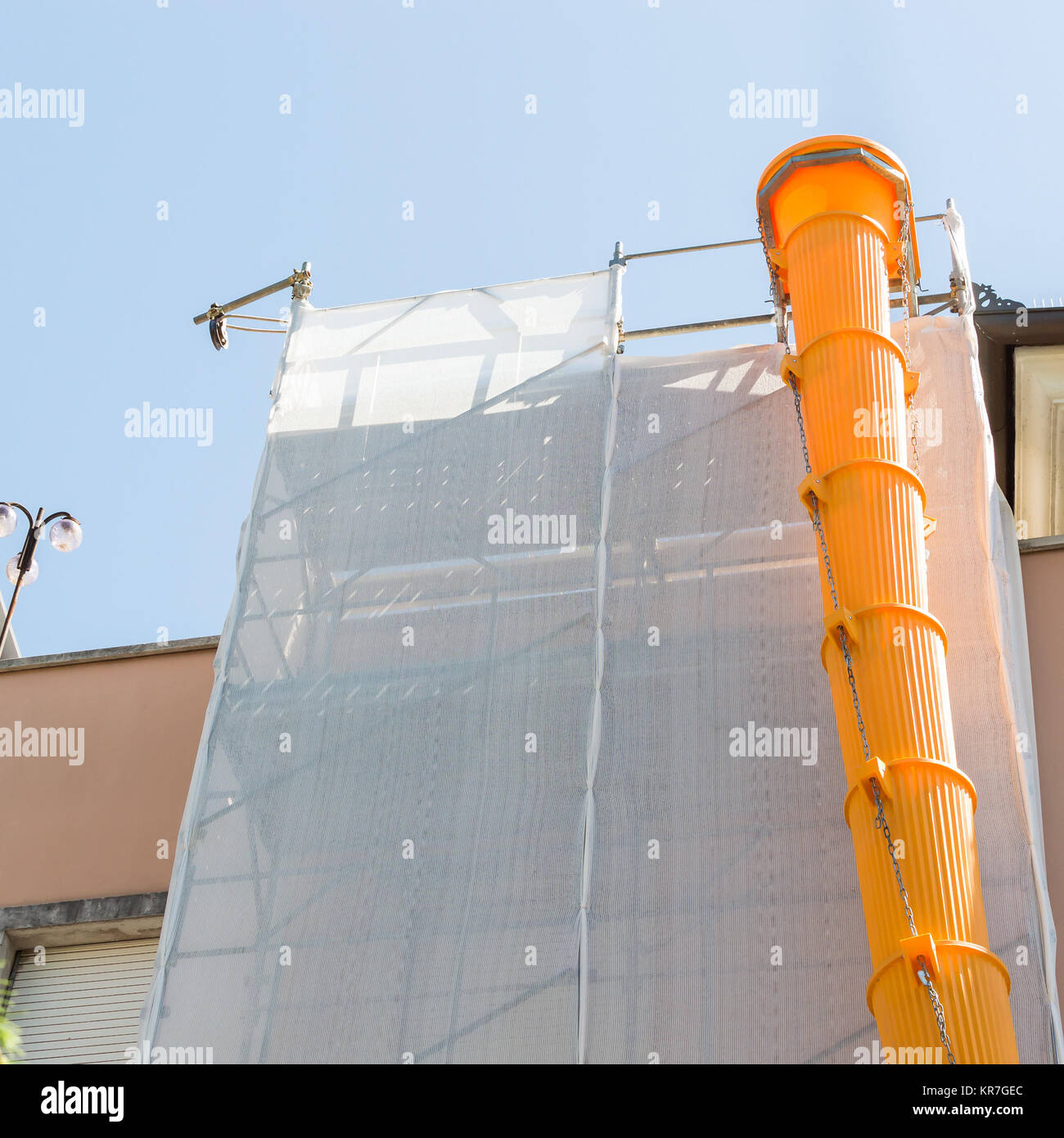 Scaffolding covered with modular slide for debris and rubble Stock ...
