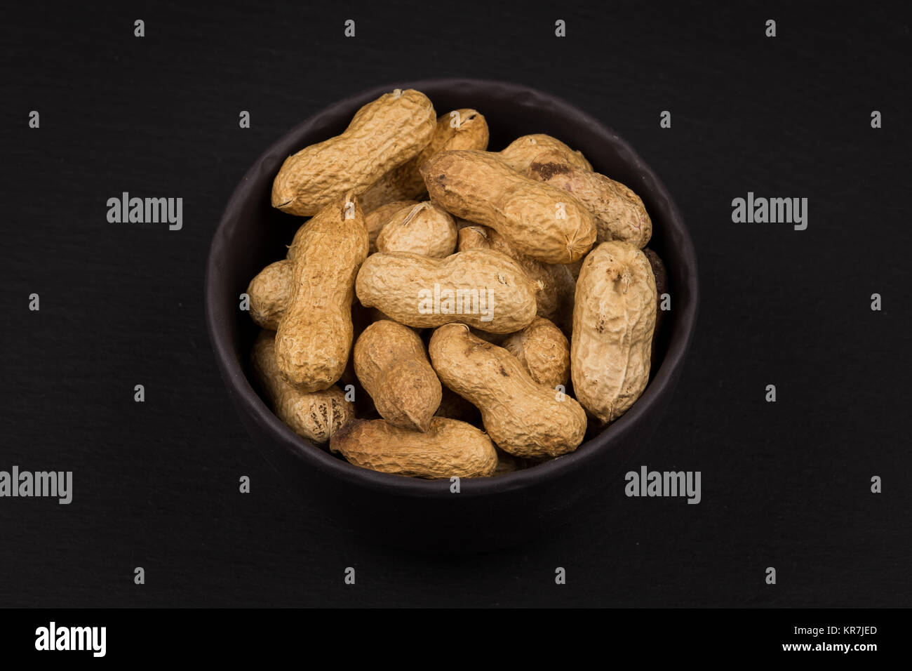 Raw peanuts shells in bowl Stock Photo - Alamy