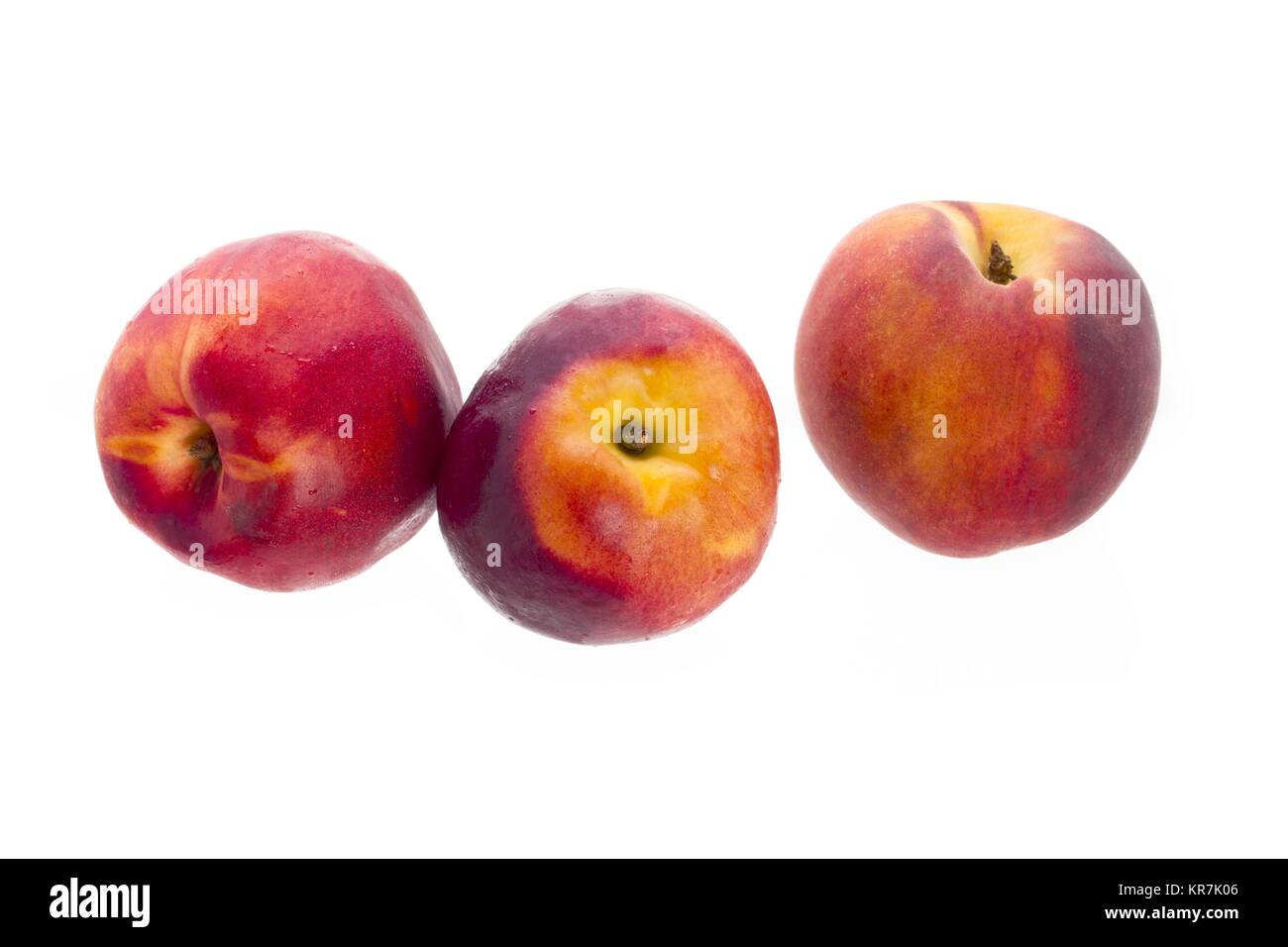 three peaches displayed on white background Stock Photo - Alamy