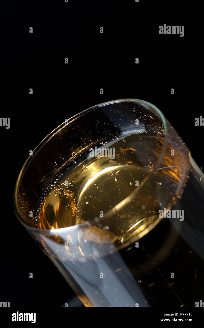 tilt glass filled with champagne Stock Photo - Alamy