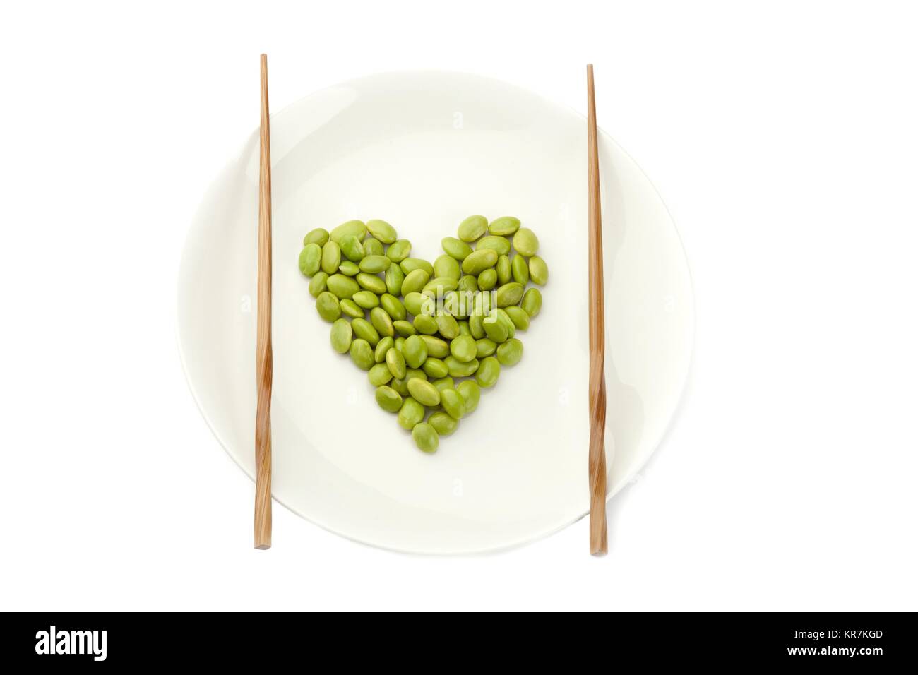 view of a plate with chopsticks while beans arranged in heart shape ...