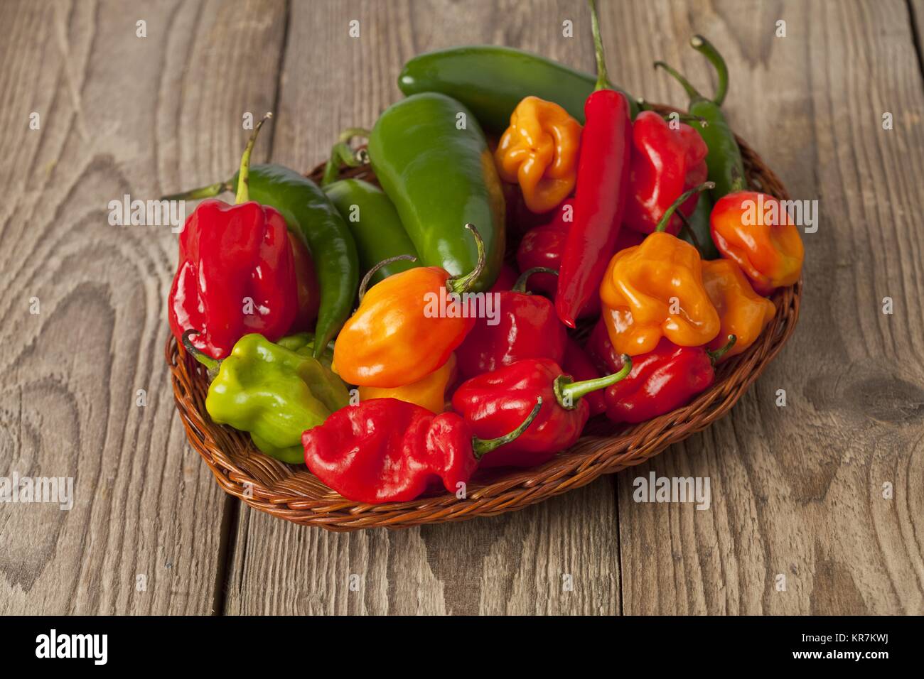 wooden platter with hot peppers Stock Photo - Alamy