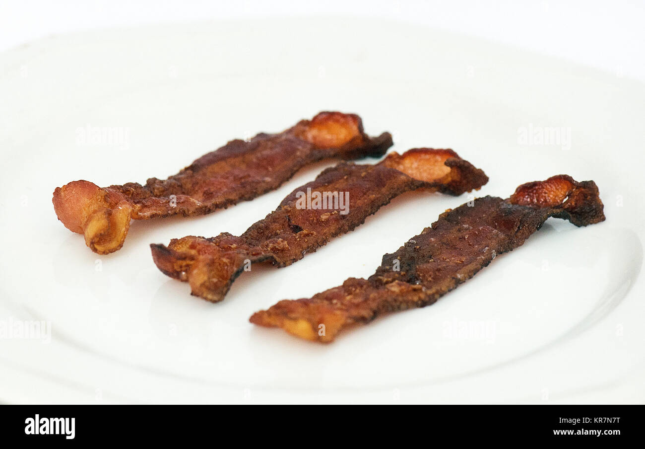Strips of crispy bacon is shown on a plate Stock Photo - Alamy