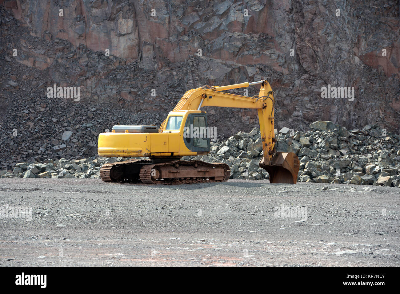Earthmover in an active quarry mine of porphyry rocks. digging Stock ...