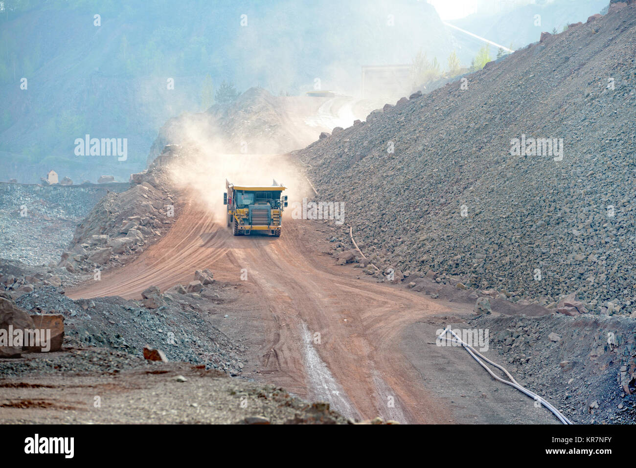 dumper truck driving in an active quarry mine of porphyry rocks ...
