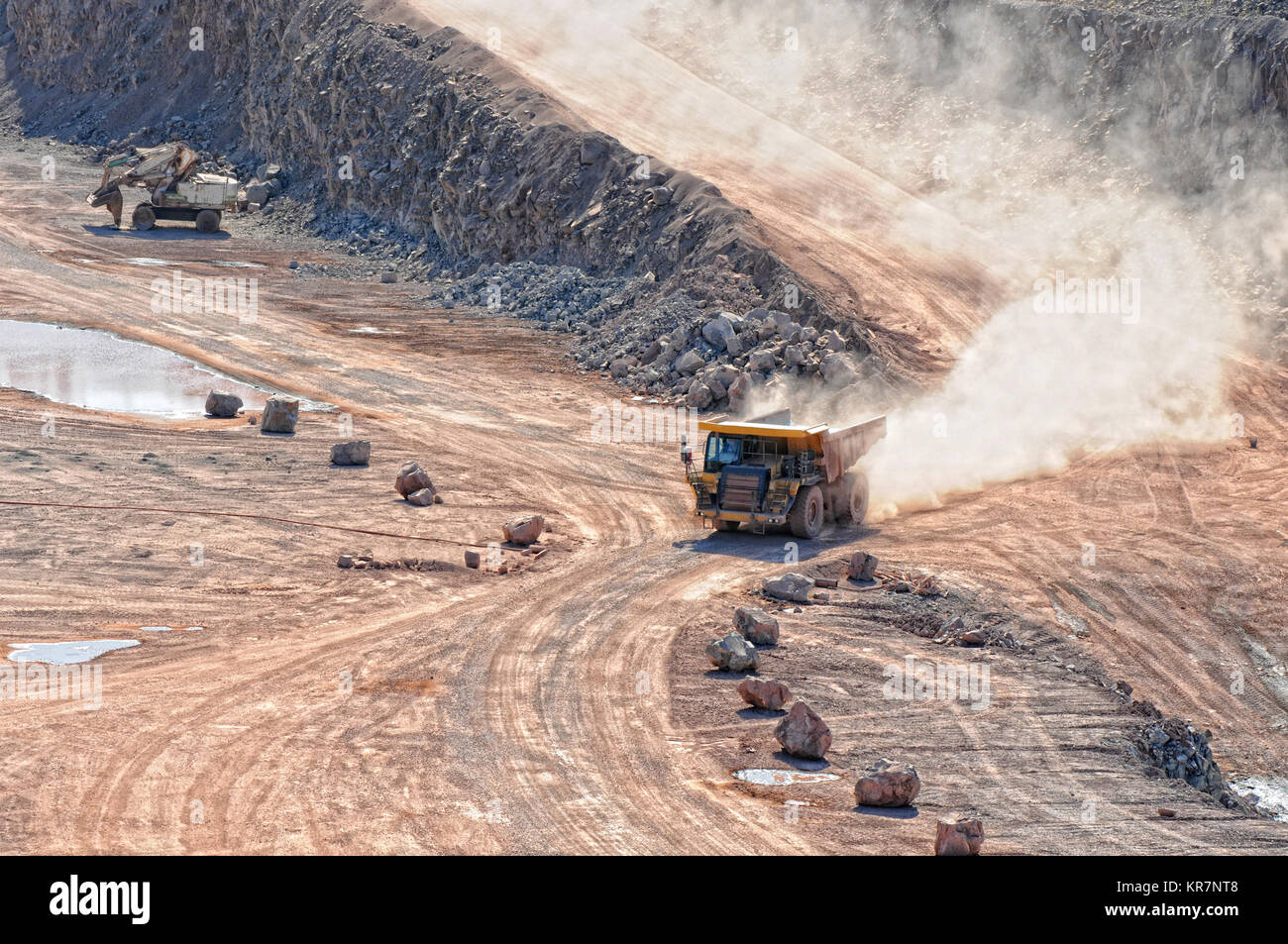 dumper truck driving in an active quarry mine of porphyry rocks ...