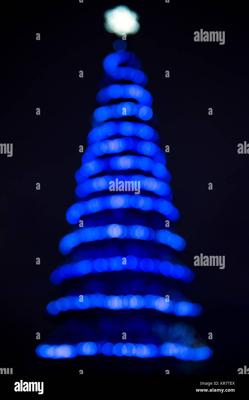 Defocused christmas tree silhouette with blurred blue lights Stock ...